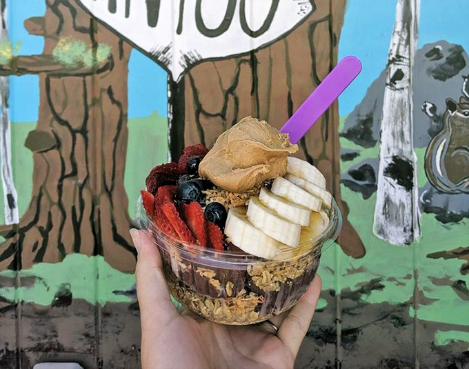 A vacation for your taste buds: fresh fruit, granola, and peanut butter create an acai bowl that's both virtuous and indulgent.