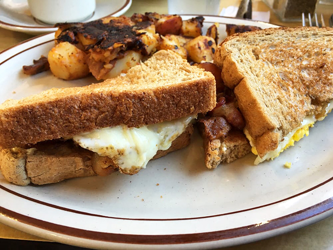 The breakfast sandwich that launched a thousand napkins. Melty cheese, crispy bacon, and eggs nestled between perfectly toasted bread—simple perfection.