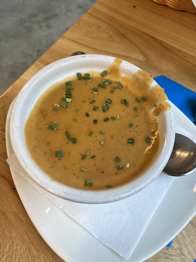 A bisque garnished with fresh chives that's so velvety smooth it could teach a masterclass on texture. Comfort in a bowl.