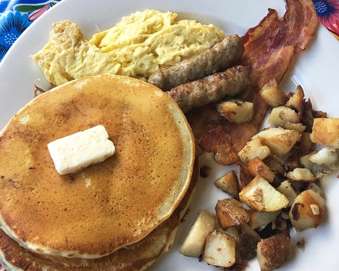 The A1 Breakfast in all its glory. Golden pancakes, perfectly cooked eggs, savory sausage, and home fries that deserve their own fan club.