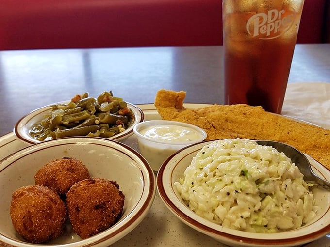 Southern comfort on a plate: green beans that actually taste like vegetables, hush puppies begging for attention, and rice that's found its purpose.