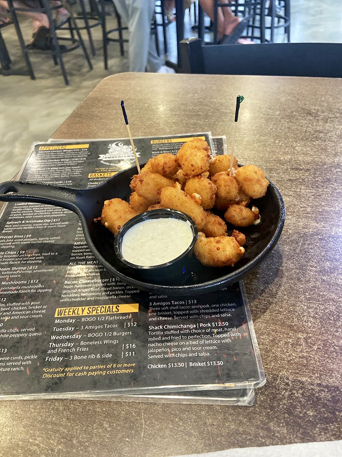 Wisconsin cheese curds that squeak with freshness, golden-fried to perfection. The dipping sauce is just a formality at this point.