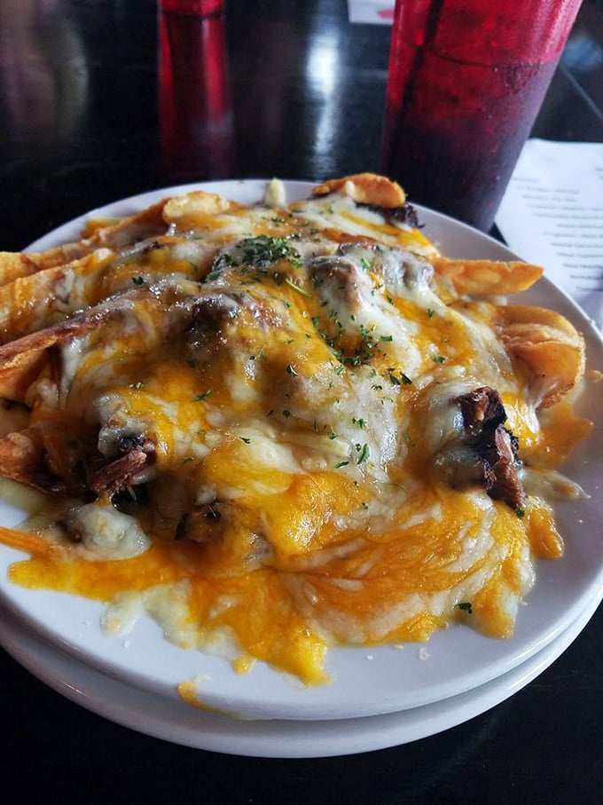 These loaded cheese fries aren't just a side &ndash; they're the main event. Melted cheese blankets every crispy surface, topped with what appears to be brisket.