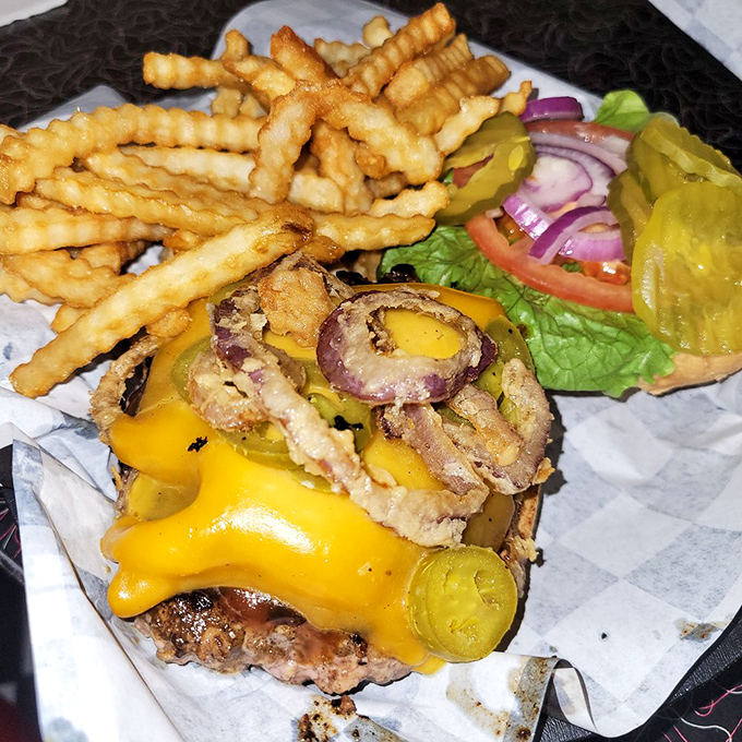 This isn't just a cheeseburger—it's architecture. Layers of melty cheese, crispy bacon, and jalapeños create the skyscraper of satisfaction.