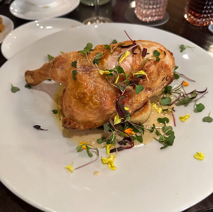 This golden-roasted chicken leg looks like it could convert vegetarians, at least temporarily, with its perfectly crisped skin and herb garnish.