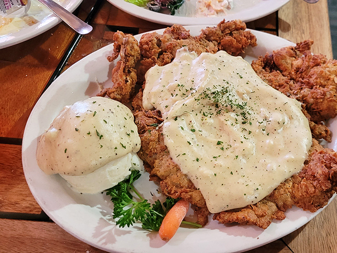 Chicken fried steak that's achieved the impossible: crispy exterior, tender interior, and enough cream gravy to make your cardiologist wince approvingly.