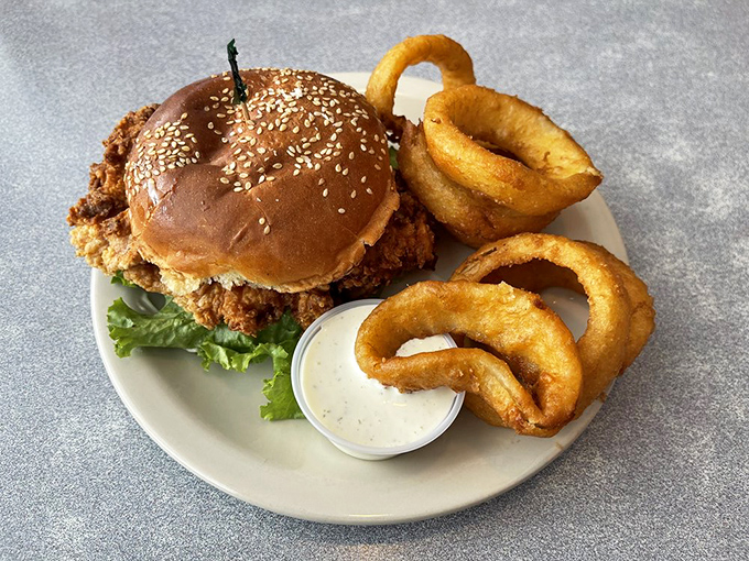 A sandwich that requires both hands and several napkins&mdash;the golden onion rings standing guard like delicious sentinels of crunch.