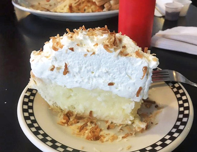 Coconut cream pie that makes you question all other desserts. That mountain of whipped cream isn't just decoration&mdash;it's a lifestyle choice.