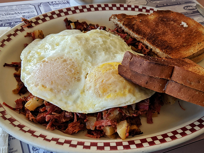 Corned beef hash topped with perfectly fried eggs and toast&mdash;breakfast doesn't get more satisfying than this classic combination done right.