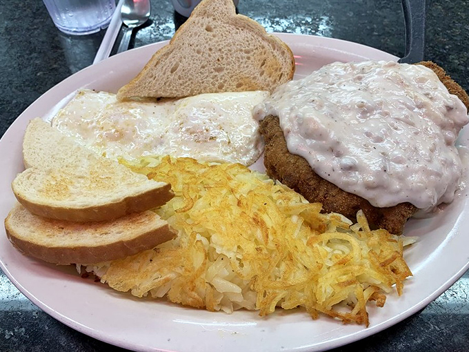 Country fried steak with gravy isn't diet food—it's soul medicine, served with hash browns so perfectly golden they deserve their own Instagram account.