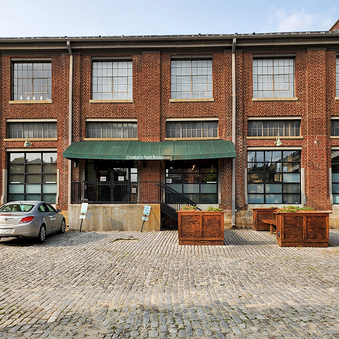 Croaker's Spot occupies a beautifully repurposed industrial building where the cobblestone street adds extra character. Those outdoor planters aren't just decorative – they're a welcome sign.