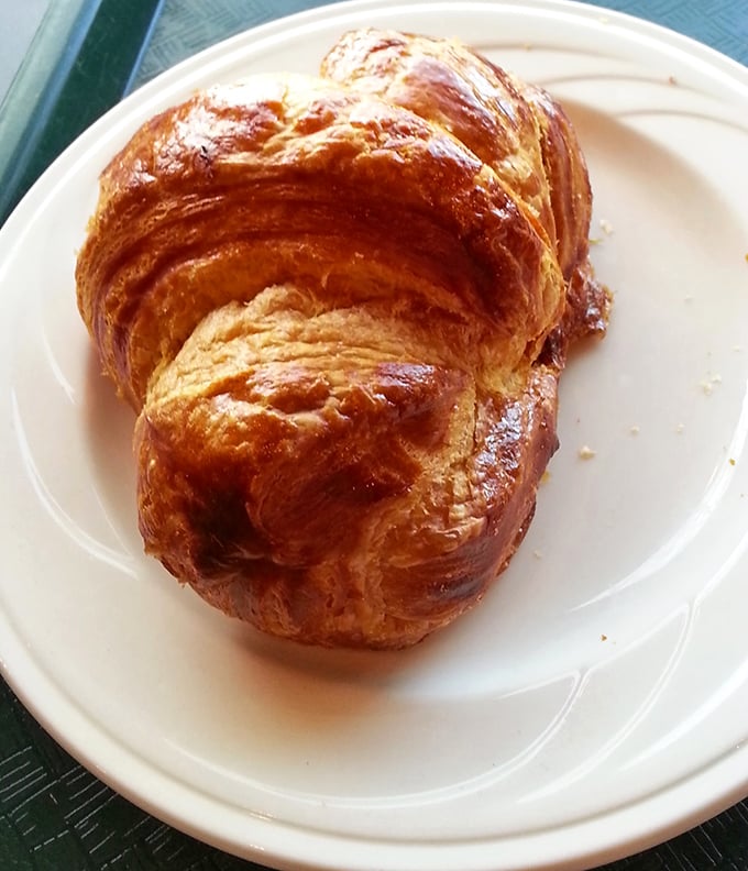 The croissant doesn't just look good&mdash;it's practically auditioning for a French baking competition with those perfectly laminated, honey-bronzed layers.