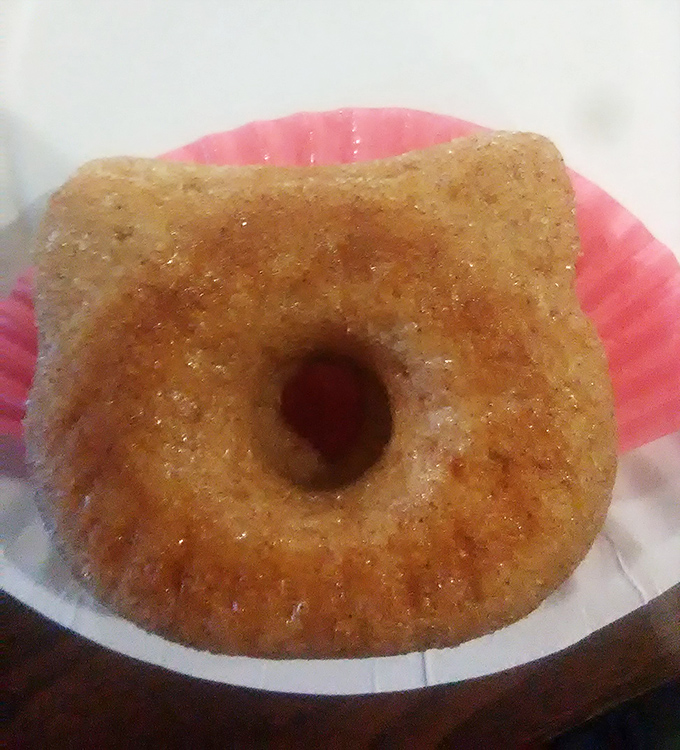 This golden donut, perfectly fried and glistening with sugar, sits ready to complement your morning coffee ritual.