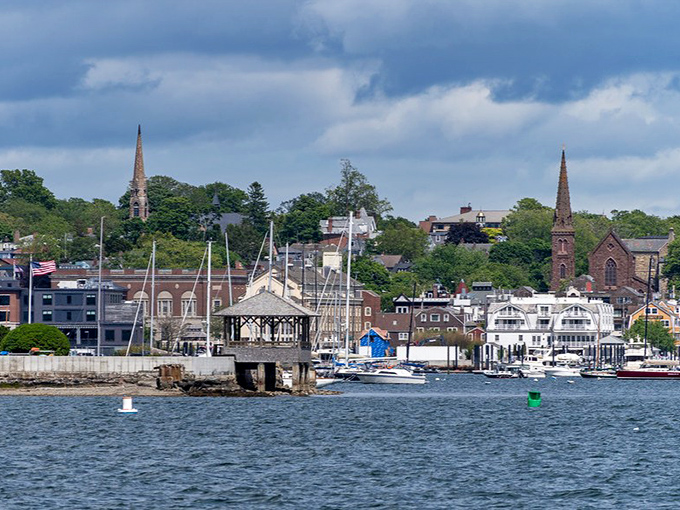 Newport Harbor: where boats worth more than your mortgage bob peacefully against a backdrop of church spires and historic buildings.