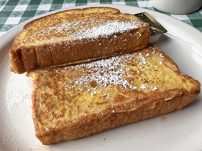 French toast so perfectly golden it belongs in Fort Knox, dusted with powdered sugar that makes every bite a celebration.