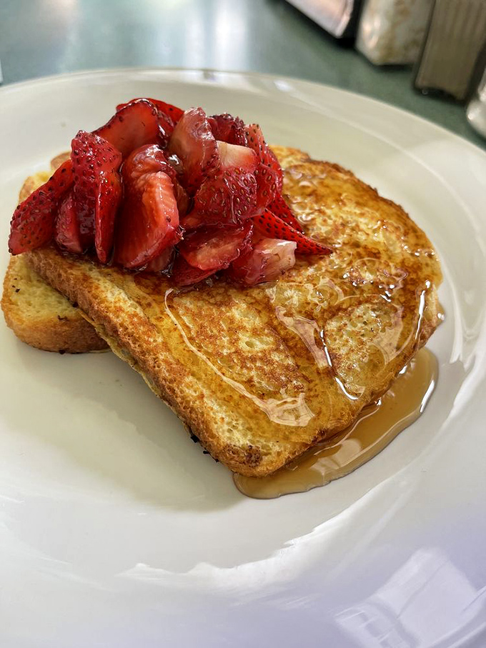French toast that makes you question why you ever bother making it at home, topped with strawberries that actually taste like strawberries.