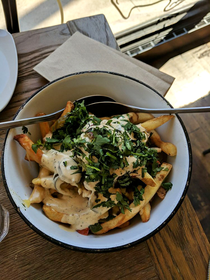 Fries elevated to art form status with a blanket of herb-flecked sauce. Proof that sometimes the supporting actors steal the show.