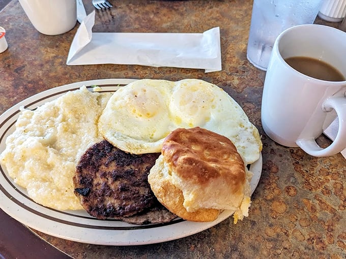 Simple perfection: eggs, hamburger steak, and a biscuit that could make a grown Cajun cry tears of buttery joy.