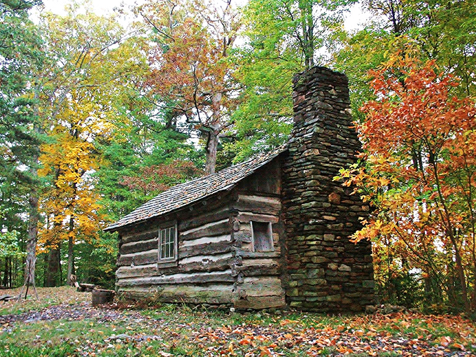 This historic log cabin, embraced by autumn's palette, looks like it's waiting for Daniel Boone himself to return for supper.