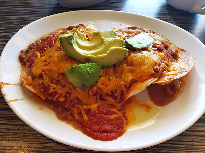 Huevos rancheros reimagined with Florida flair. Melted cheese and avocado crown this breakfast fiesta that would make any morning memorable.
