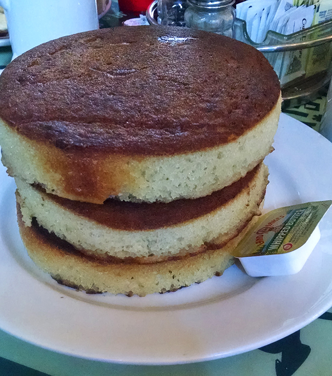 Three pancakes stacked like edible flying saucers prove that bigger really is better at breakfast.