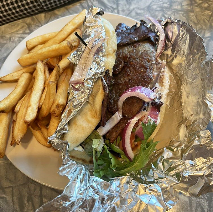 Who needs a passport to Greece when this gyro brings Mediterranean flavors wrapped in foil and nestled beside a mountain of golden fries?
