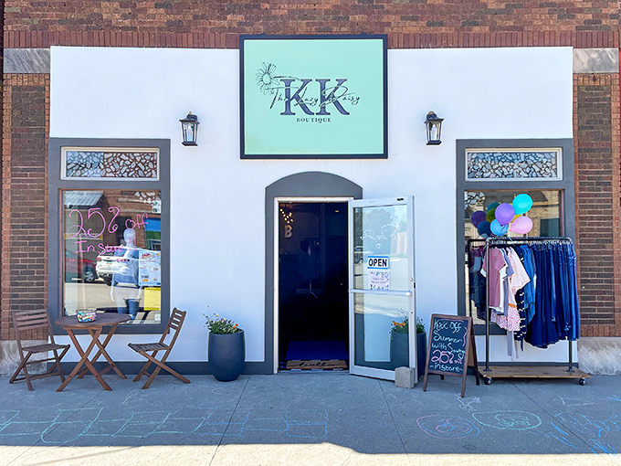Lazy Daisy Boutique brings small-town charm to fashion with its inviting storefront, where sidewalk chalk art and colorful displays beckon shoppers inside.