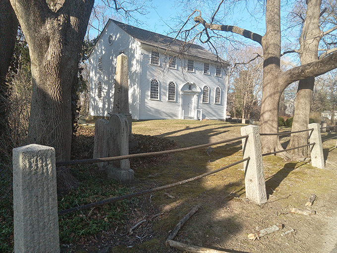 The Old Narragansett Church whispers stories from 1707, surrounded by gravestones that serve as the original status updates of their day.