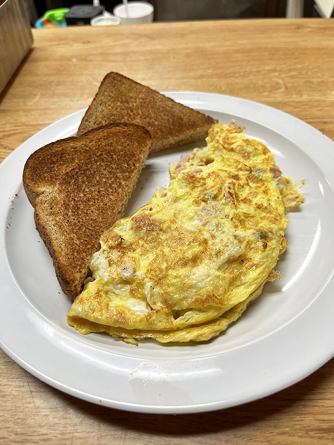 This isn't just an omelet; it's breakfast architecture&mdash;perfectly folded eggs alongside toast that's achieved that magical golden-brown sweet spot.