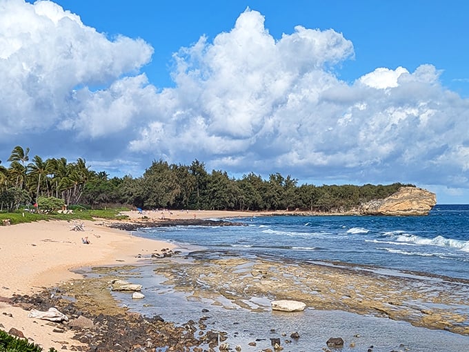 This pristine stretch of Poipu Beach showcases nature's perfect balance&mdash;azure waters meeting golden sands with a dramatic volcanic headland standing sentinel.