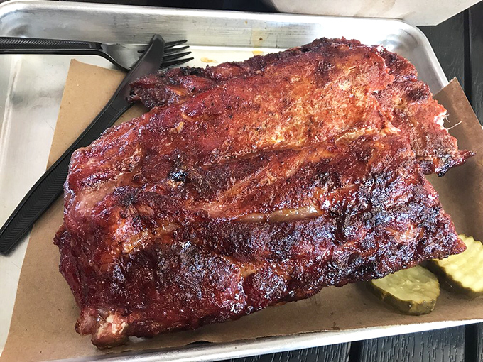 These ribs don't just fall off the bone—they practically leap into your mouth with that perfect pink smoke ring and glistening bark.