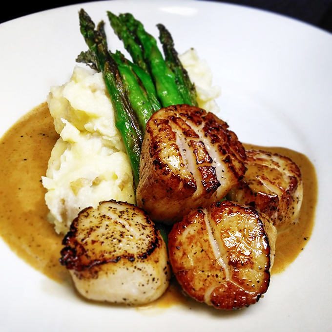 Scallops seared to golden perfection, like little ocean marshmallows that decided to dress up for a fancy night out.