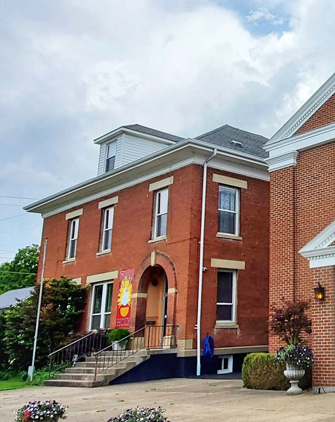 This stately brick building with its welcoming steps and colorful banner represents another piece of Augusta's rich architectural tapestry.