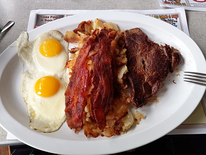 The breakfast of champions &ndash; two sunny-side eggs, crispy bacon, home fries, and a steak that answers the eternal question: "Why not have it all?"