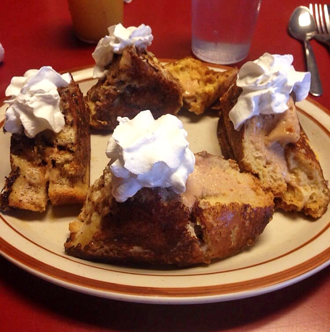 Stuffed French toast that looks like it's auditioning for a Food Network show, complete with whipped cream clouds and cinnamon swagger.
