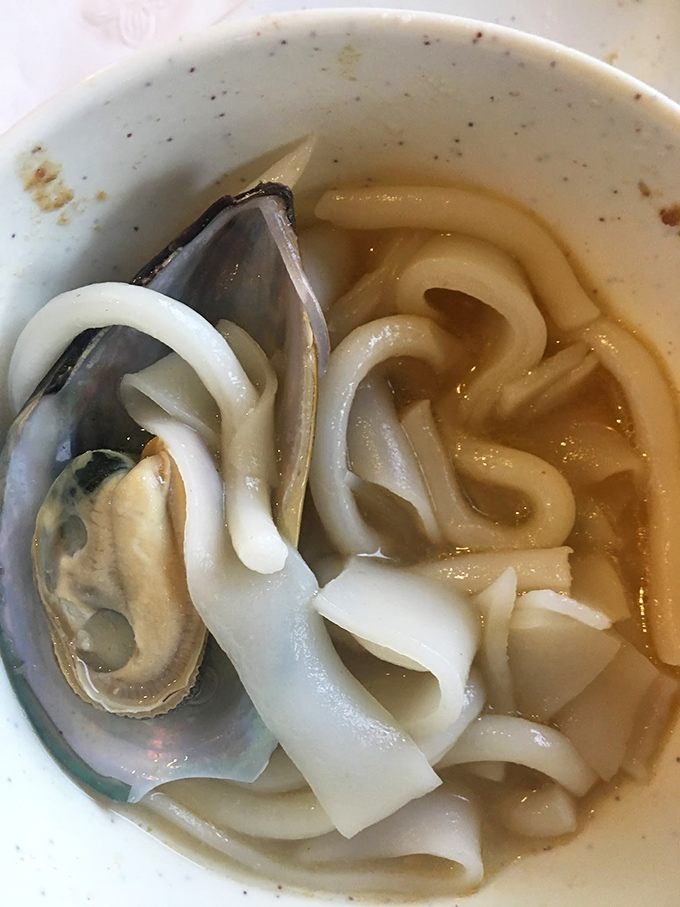 Silky udon noodles swimming alongside a plump mussel&mdash;the perfect finale to absorb that broth you've been flavoring all evening.