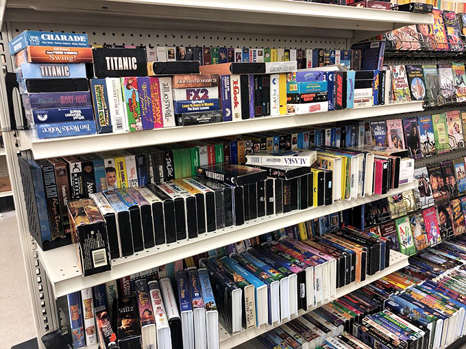 The VHS section is where "Titanic" meets "Care Bears" in a nostalgic reunion of plastic cases and forgotten movie nights.