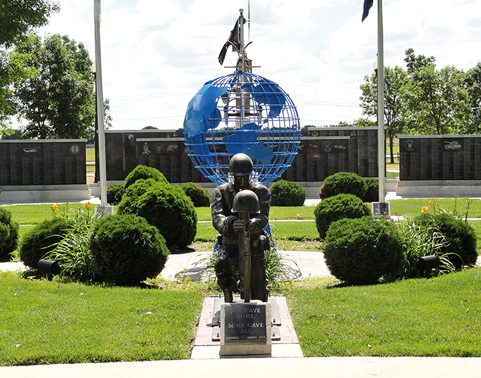 Watertown's Veterans Memorial honors service with quiet dignity. The blue globe and bronze statue create a powerful tribute to those who served.