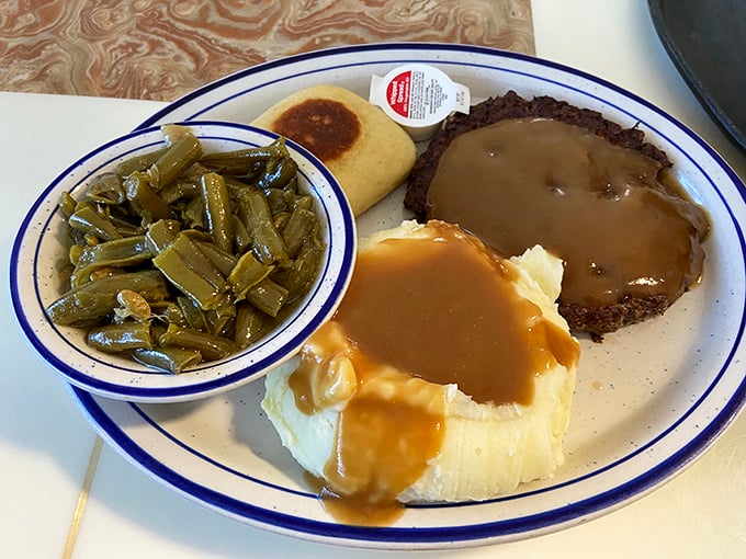 When gravy cascades over meatloaf like a savory waterfall, meeting mashed potatoes in perfect harmony. Green beans that actually taste like vegetables should.