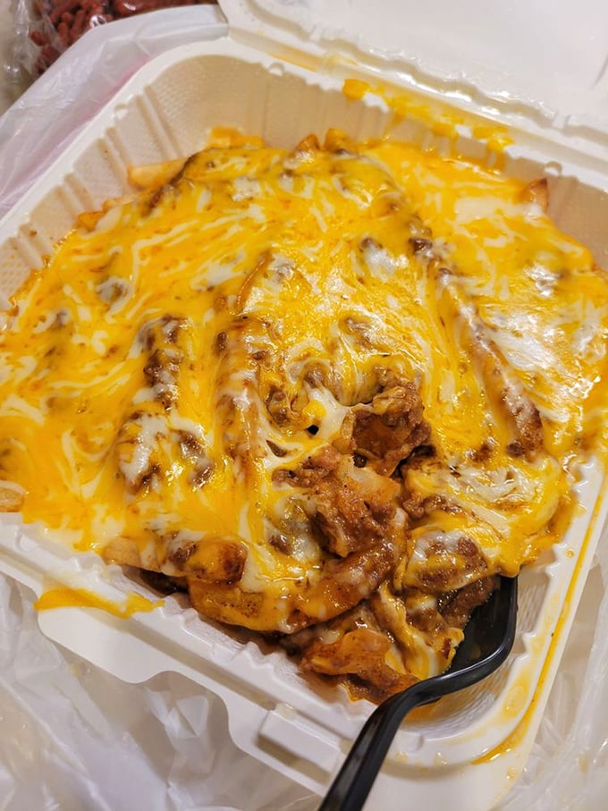 These chili cheese fries aren't messing around—they're serious comfort food wearing a molten cheddar blanket that stretches with every bite.