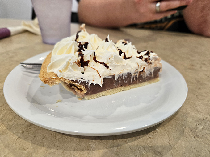 This chocolate cream pie doesn't just end a meal—it's the grand finale that makes you wonder why you wasted stomach space on vegetables.