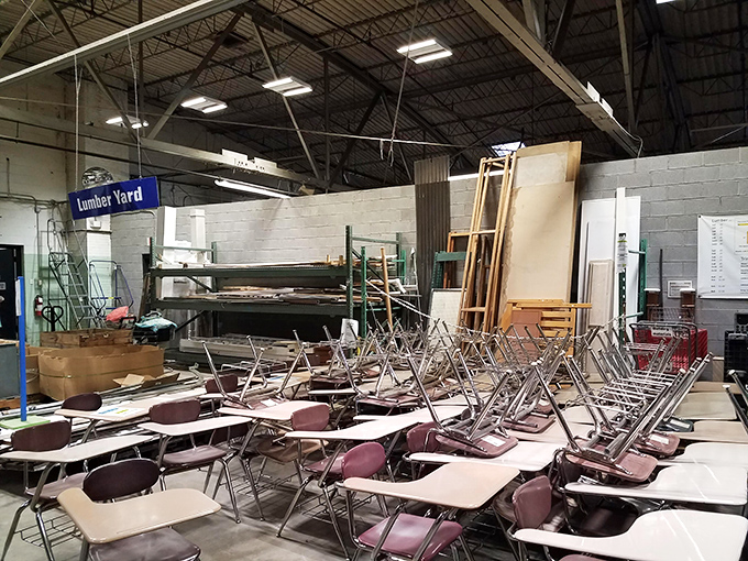 A classroom's worth of desks waiting for their second act. School might be out forever, but these sturdy survivors are ready for new assignments.