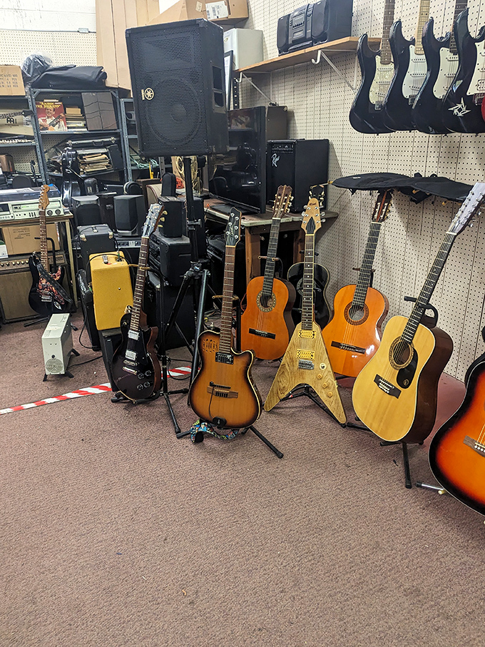 A guitarist's dream corner where vintage axes await their next rock star. That Flying V has stories it's dying to tell.