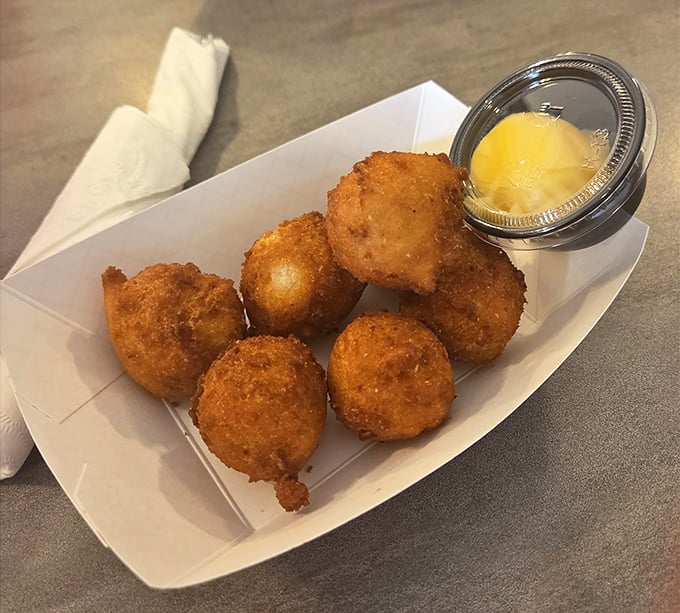 The legendary hush puppies—golden orbs of cornmeal perfection that locals drive miles for. One bite and you'll understand the obsession.