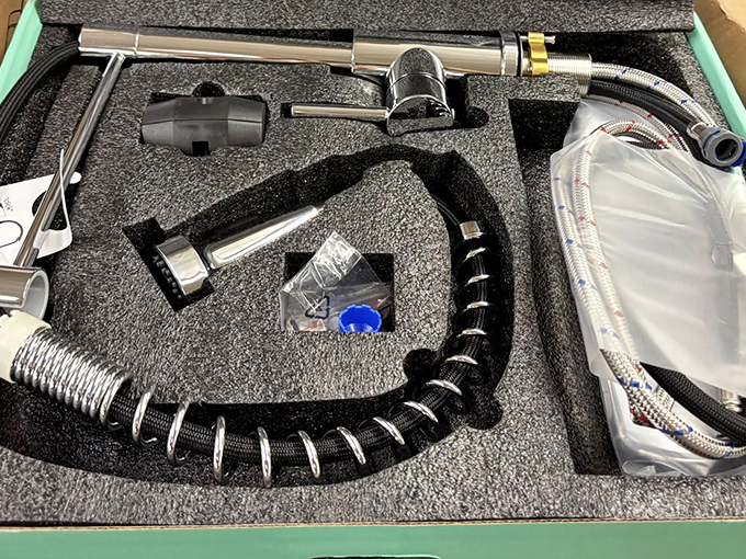 Home improvement gold! This kitchen faucet set, still in its protective foam, represents the holy grail of bin-diving: brand new items at used prices.