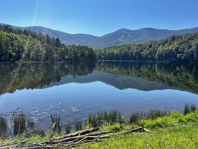 The lake's glass-like surface reflects mountains with such precision, you'll wonder which way is up. Nature's ultimate optical illusion.