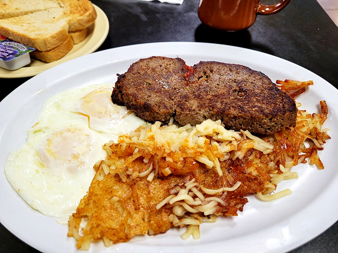 The legendary meatloaf in its natural habitat, flanked by eggs and hash browns. Not all heroes wear capes&mdash;some wear gravy.