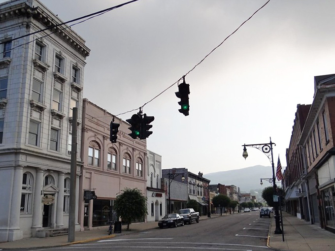 Twilight transforms Main Street into a Norman Rockwell painting with traffic lights. The mountains keep watch as day transitions to evening.