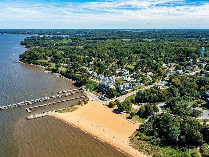 From above, Betterton reveals its secret charm&mdash;a perfect crescent of golden sand embraced by the Chesapeake's gentle waters and protective greenery.