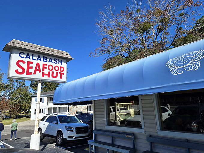 The Calabash Seafood Hut's sign stands tall like a lighthouse, guiding hungry travelers to the promised land of perfectly fried treasures.
